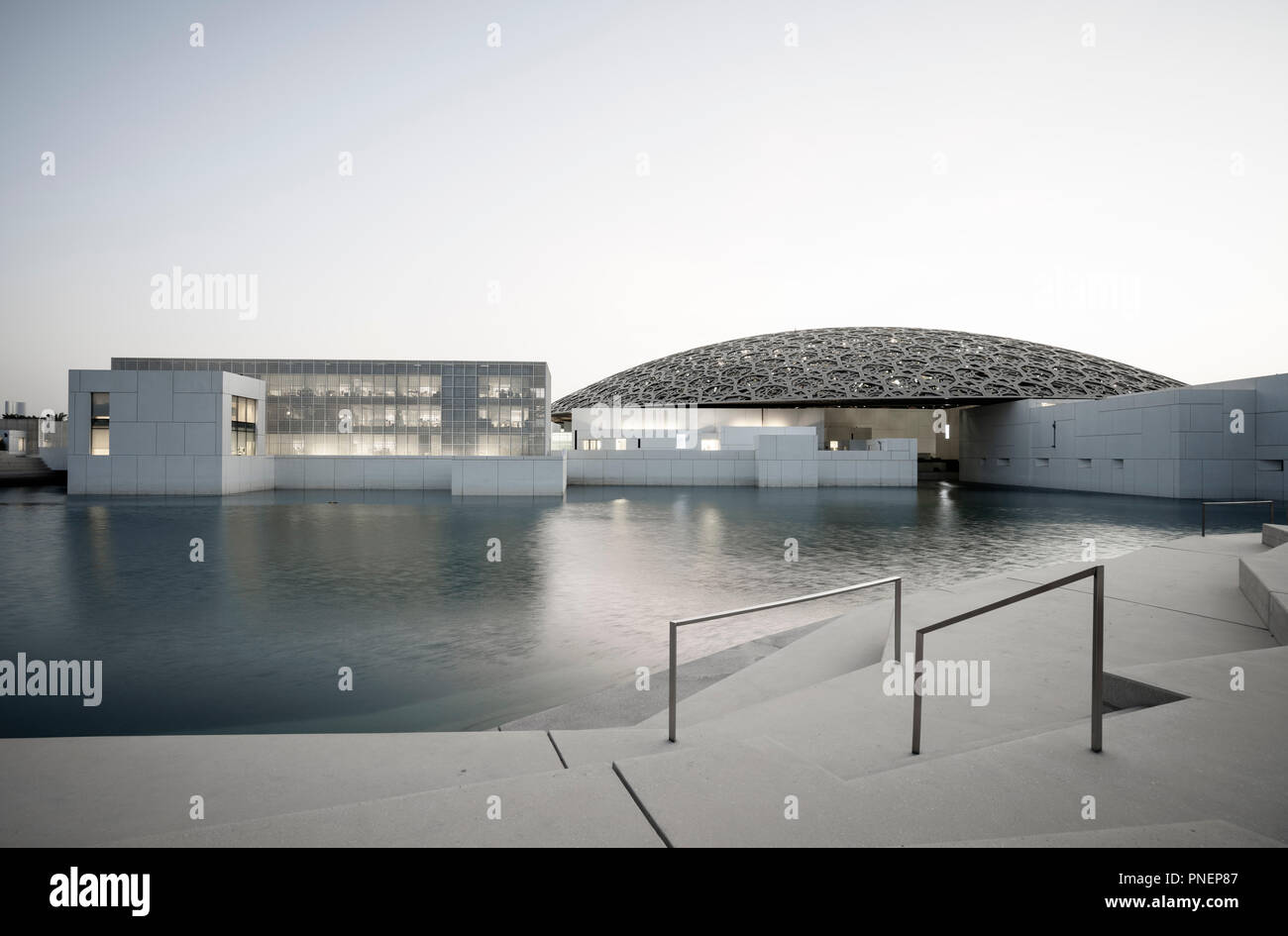 Exterior evening view of the Louvre Abu Dhabi at Saadiyat Island ...