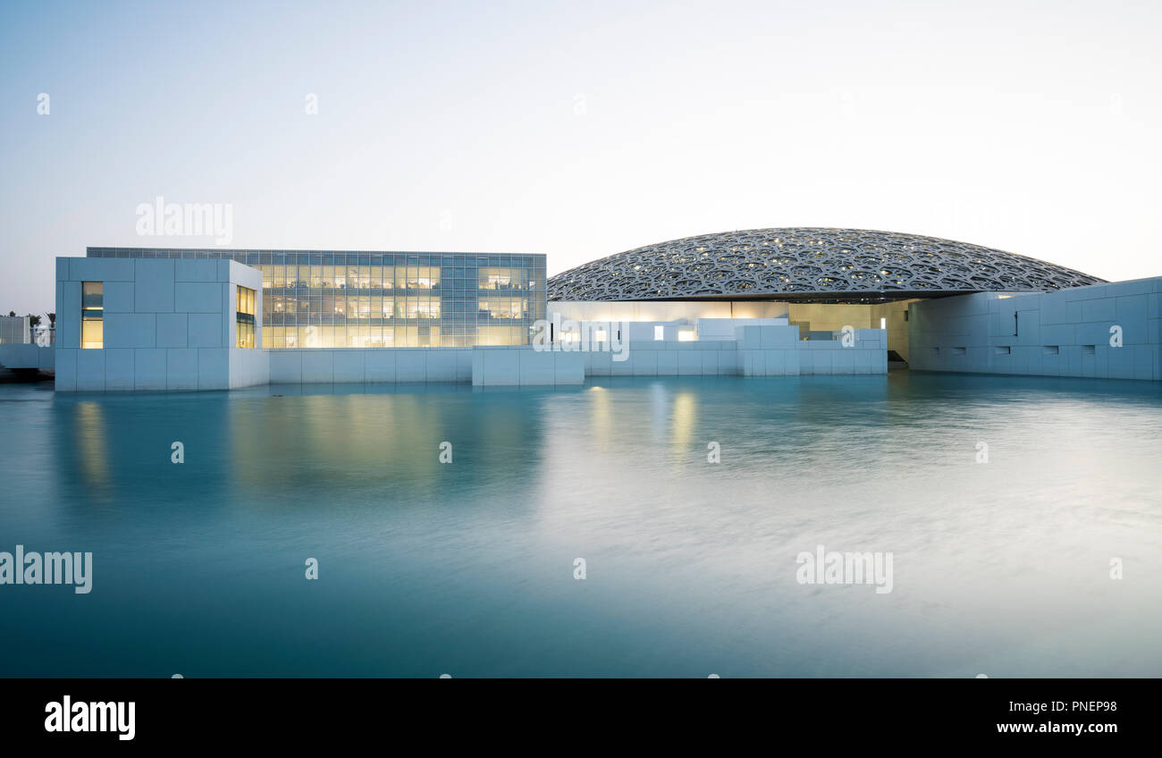 Exterior evening view of the Louvre Abu Dhabi at Saadiyat Island ...