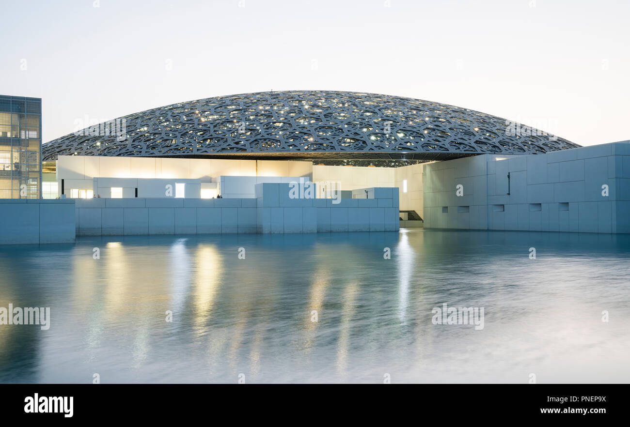 Exterior evening view of the Louvre Abu Dhabi at Saadiyat Island ...