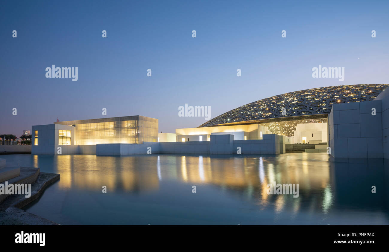 Exterior evening view of the Louvre Abu Dhabi at Saadiyat Island ...