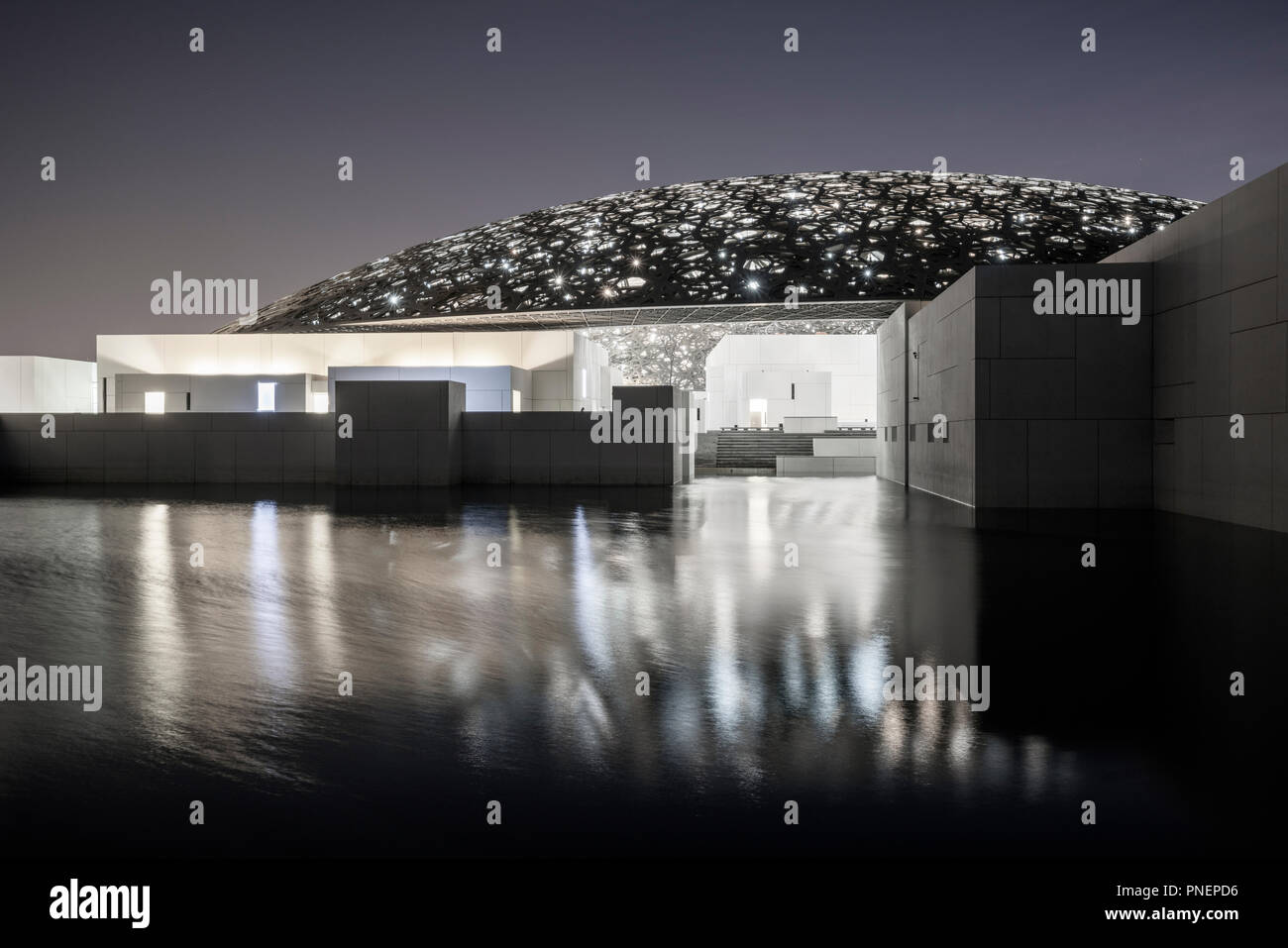Exterior evening view of the Louvre Abu Dhabi at Saadiyat Island ...