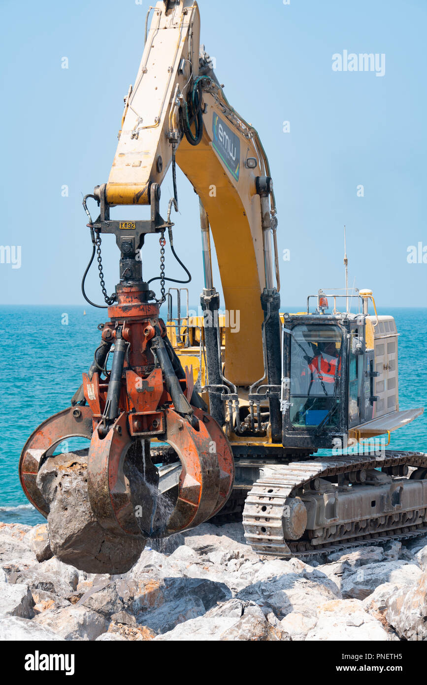 Sea defence construction work by placed large stones on shore on The ...