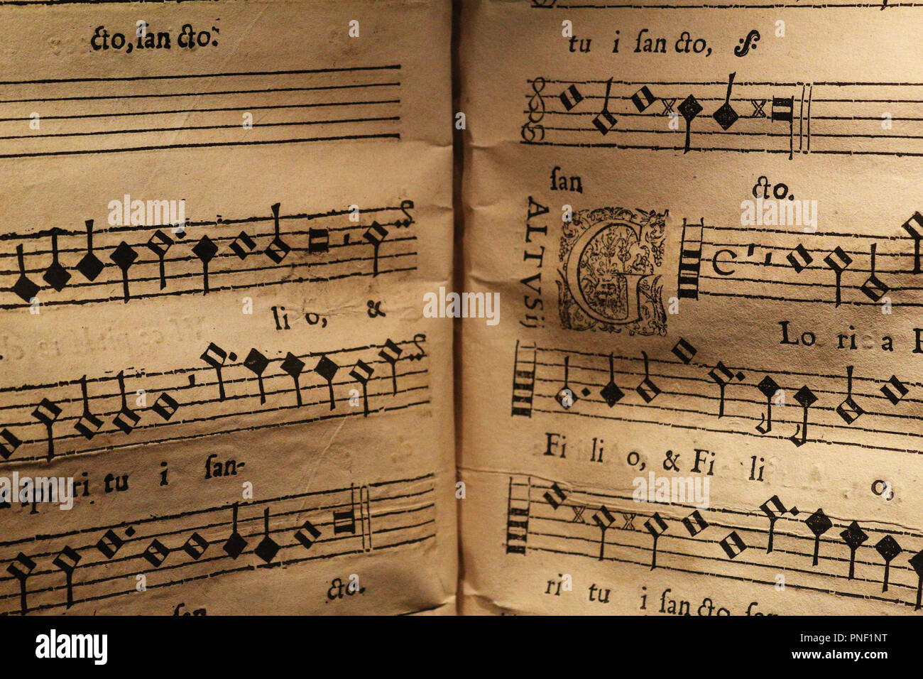An old score written on a parchment, showing a few staves with notes ...