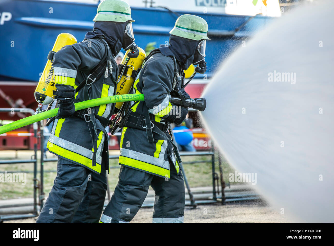 Firefighters in fire fighting, exercise, fire simulator for chemical ...