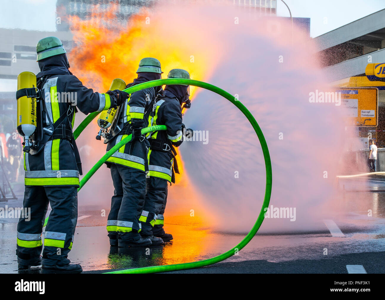 Firefighters in fire fighting, exercise, fire simulator for chemical ...