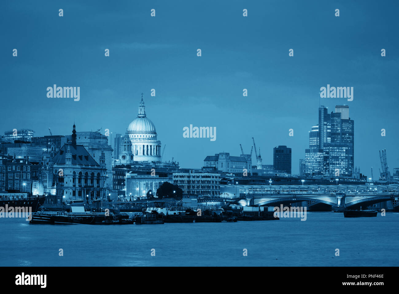 London skyline at night with bridge and St Pauls Cathedral over Thames ...