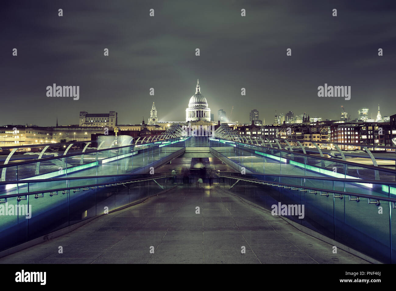 Millennium Bridge and St Pauls Cathedral at night in London Stock Photo ...