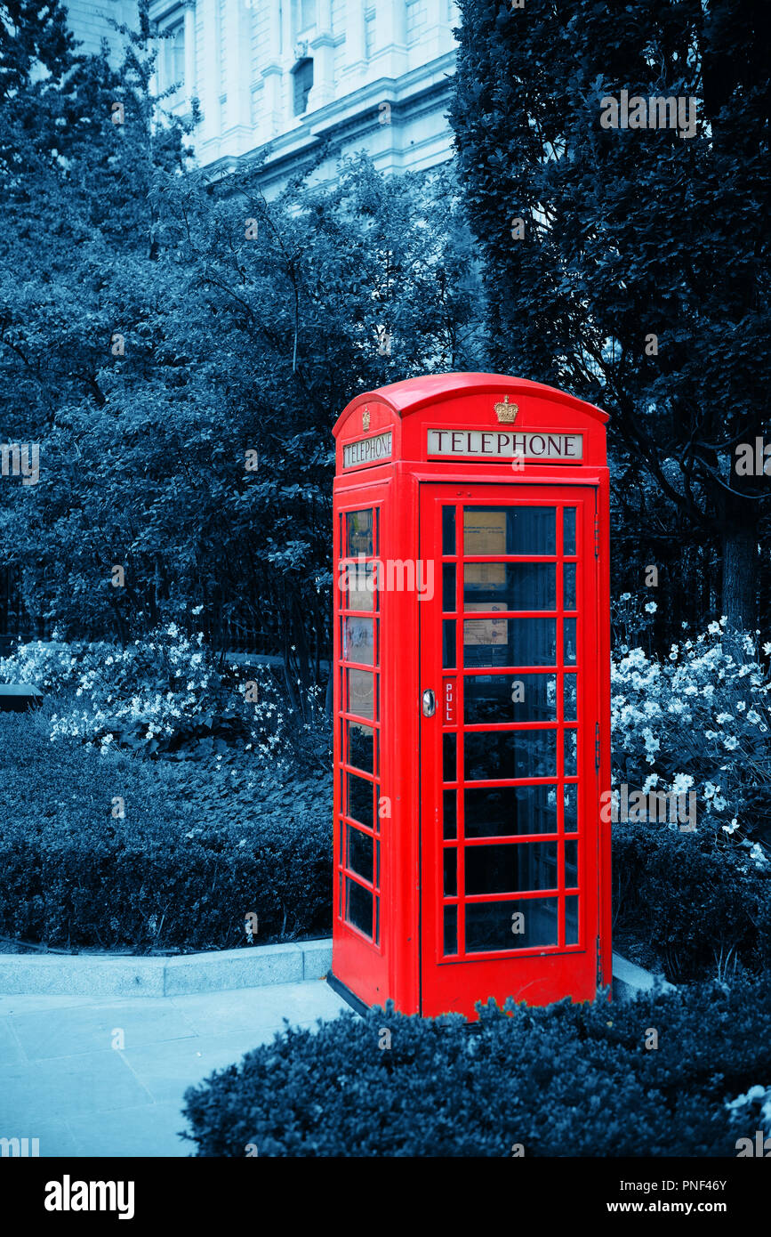 Red telephone booth in street with historical architecture in London ...