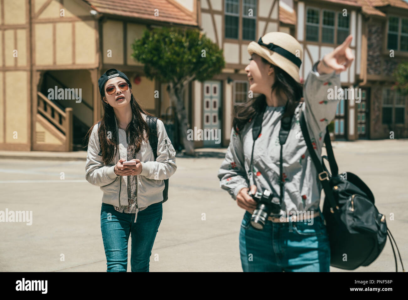 Two friends smiling pointing other hi-res stock photography and images ...