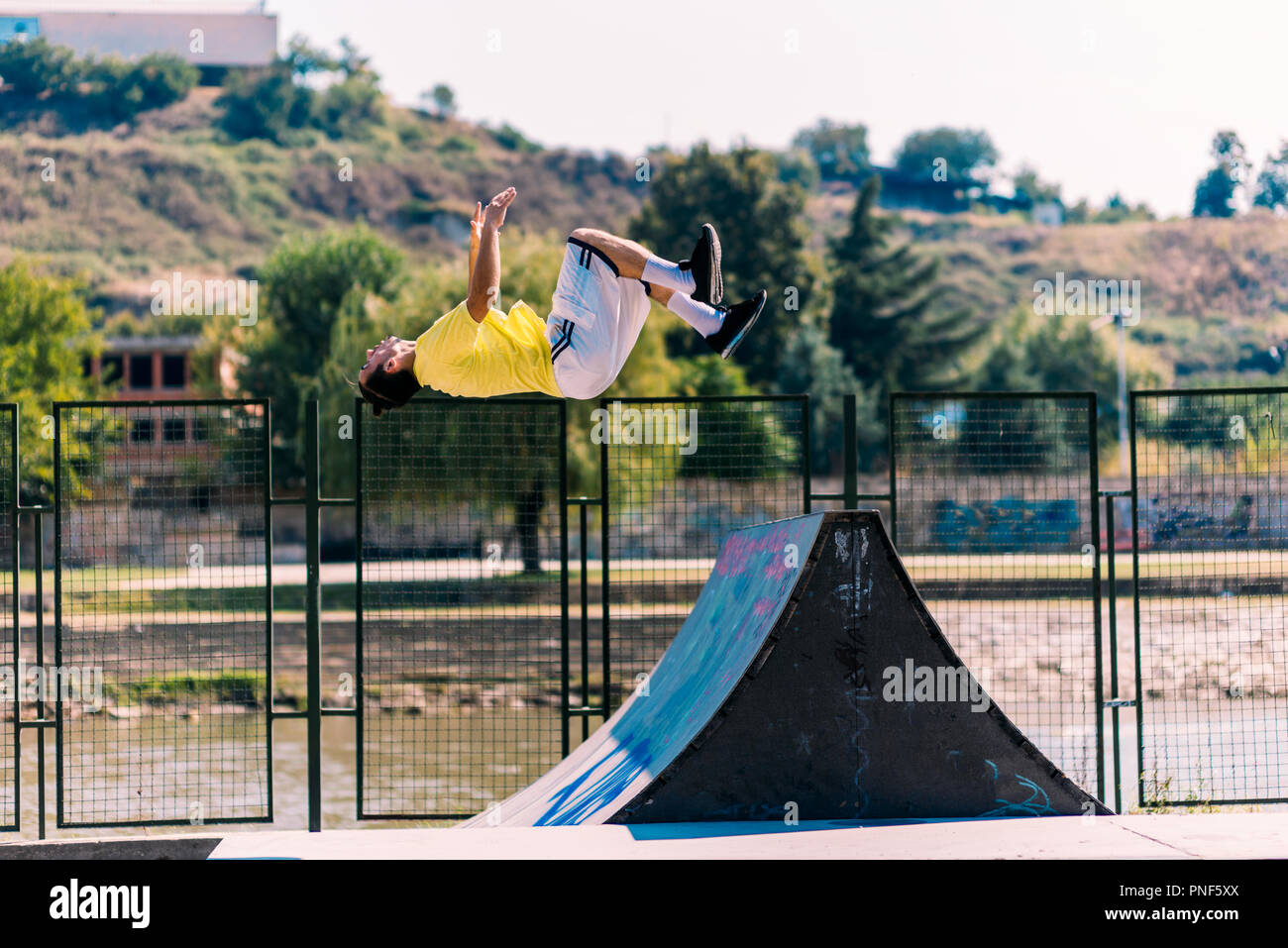 Free runner training parkour on obstacles in skatepark Stock Photo - Alamy