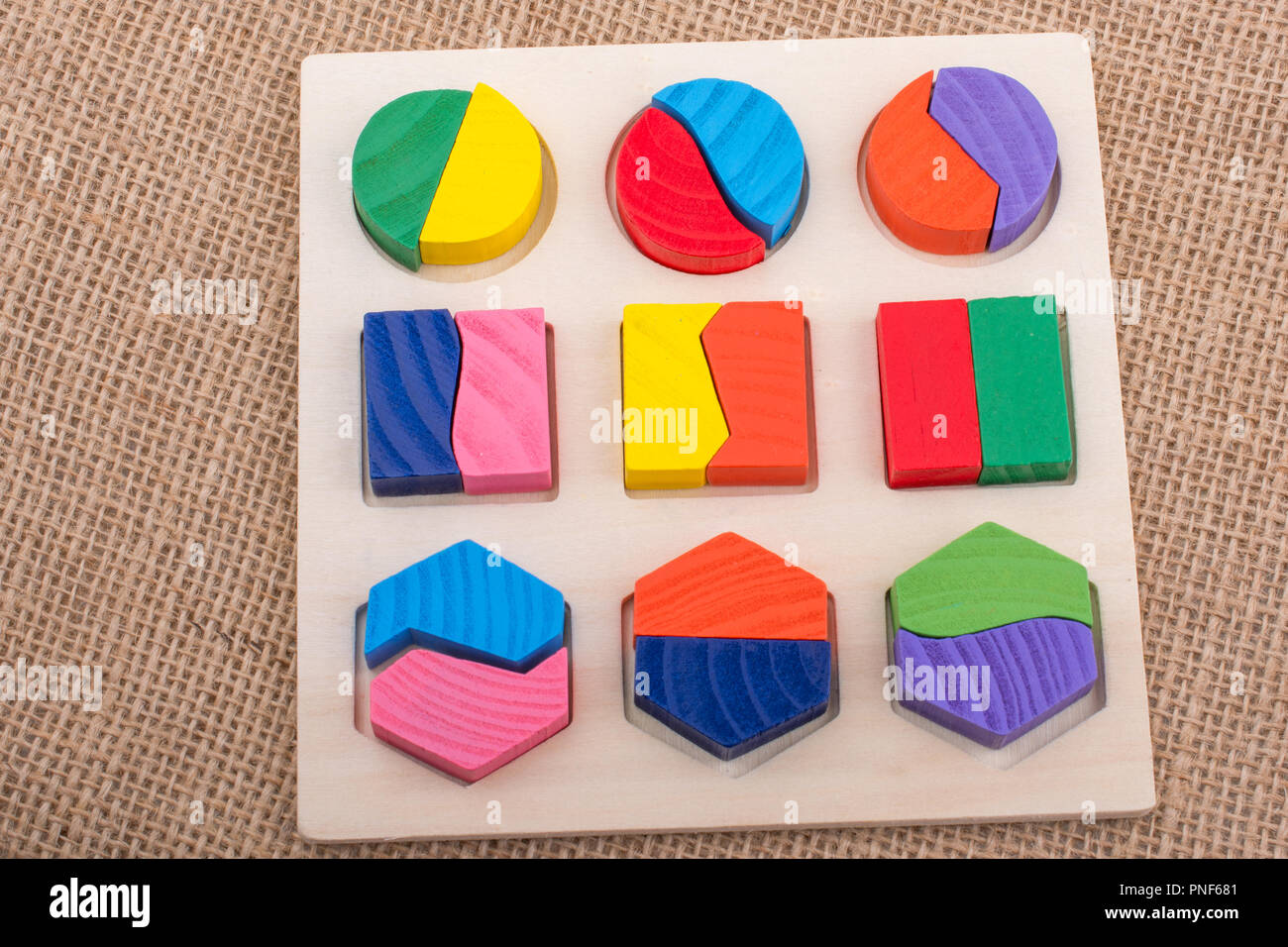 Colorful wooden pieces of a logic puzzle Stock Photo - Alamy