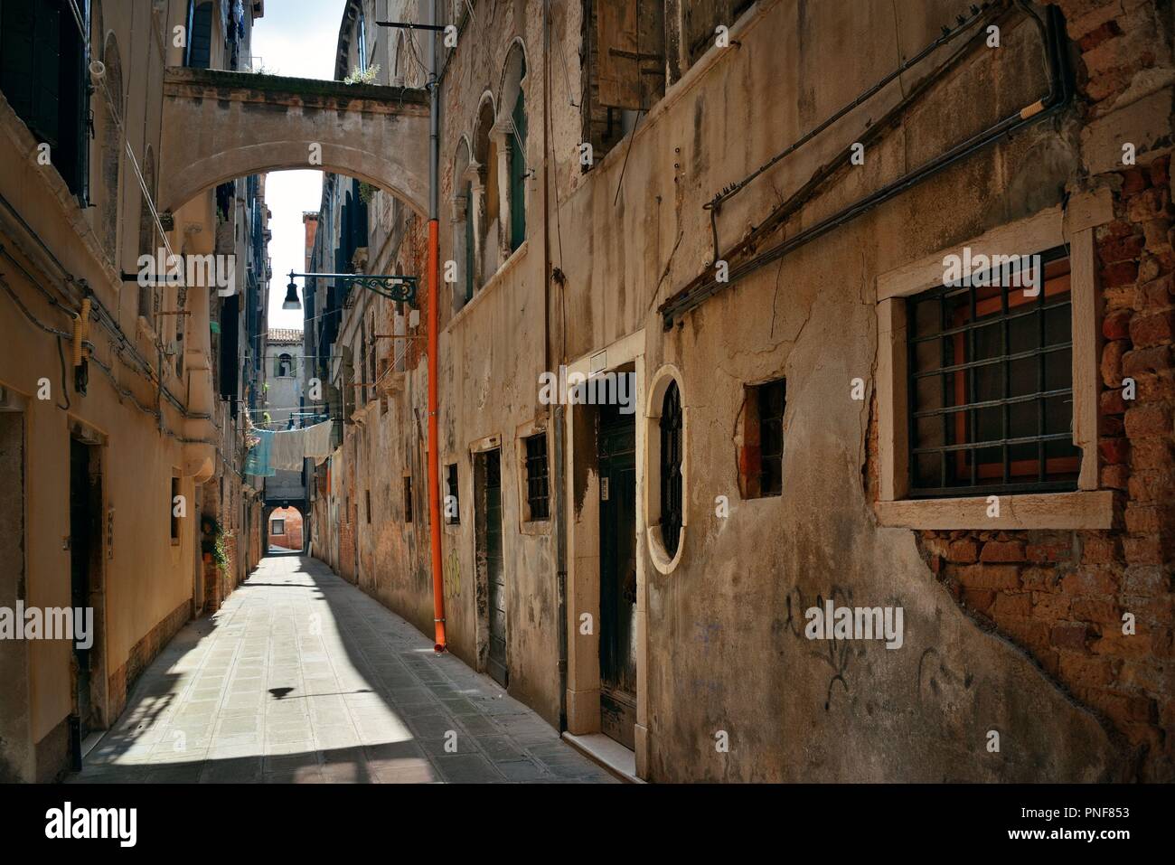 Alley view with arch and historical buildings in Venice, Italy Stock ...