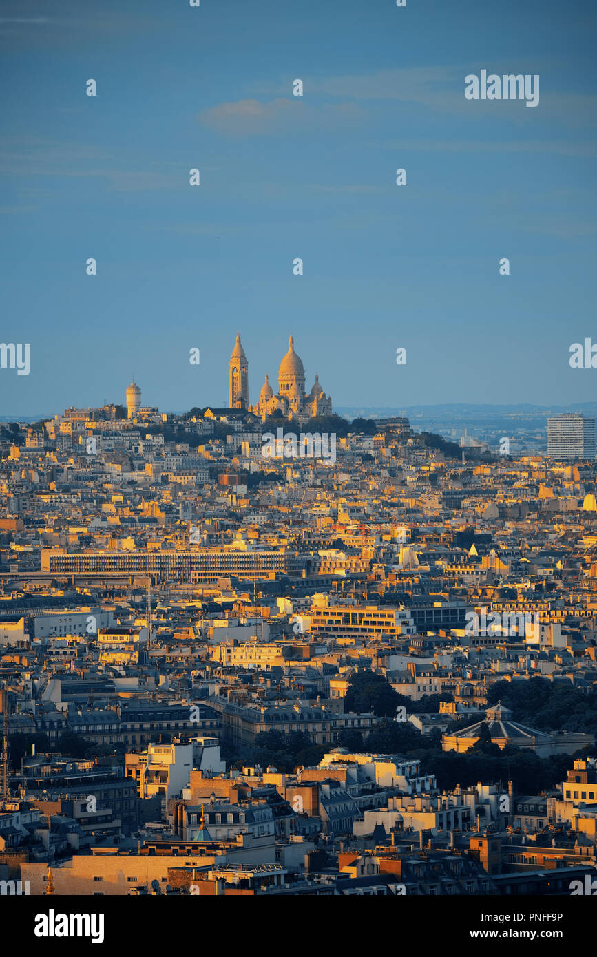 Paris city skyline rooftop view and Sacre Coeur cathedral at sunset ...