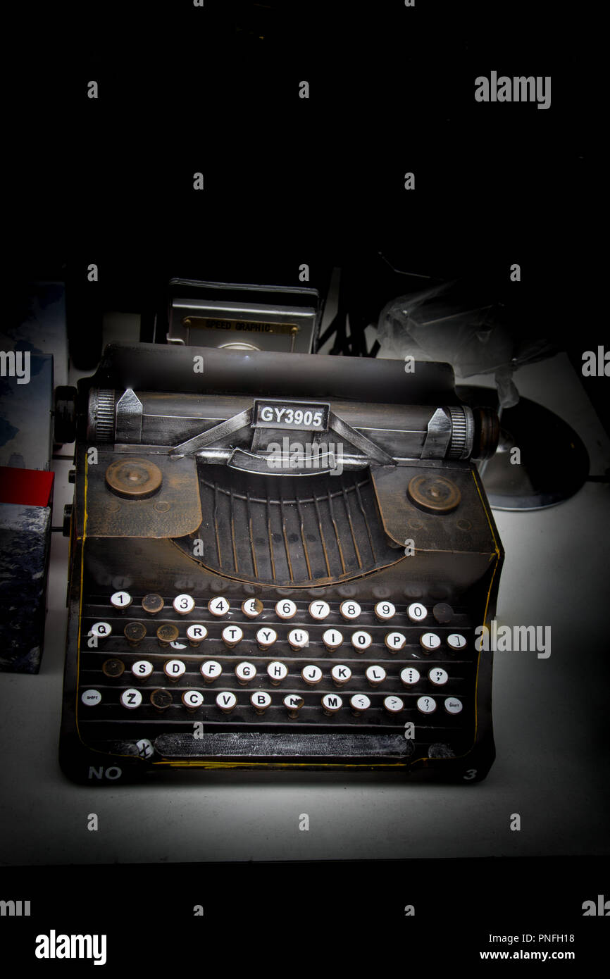 Retro syled tiny typewriter model on a white background Stock Photo - Alamy