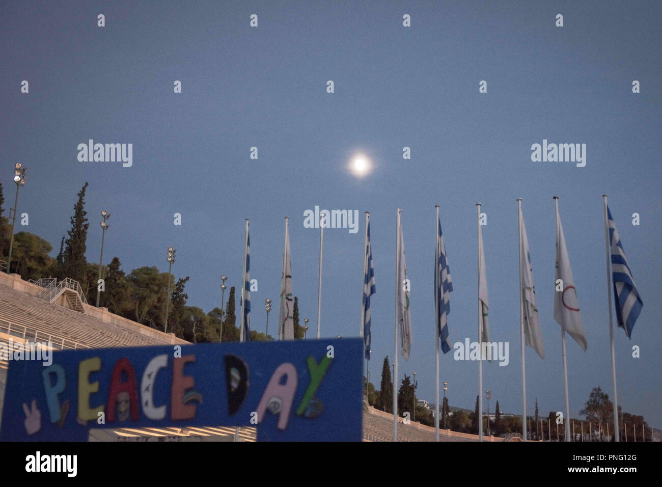 Athens, Greece. 21st Sep, 2018. The moon seen behind a peace day panel ...