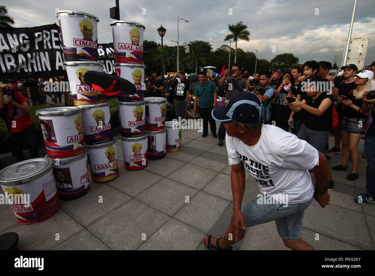 Manila, Philippines. 21st Sep, 2018. Activists throw giant flip-flops ...
