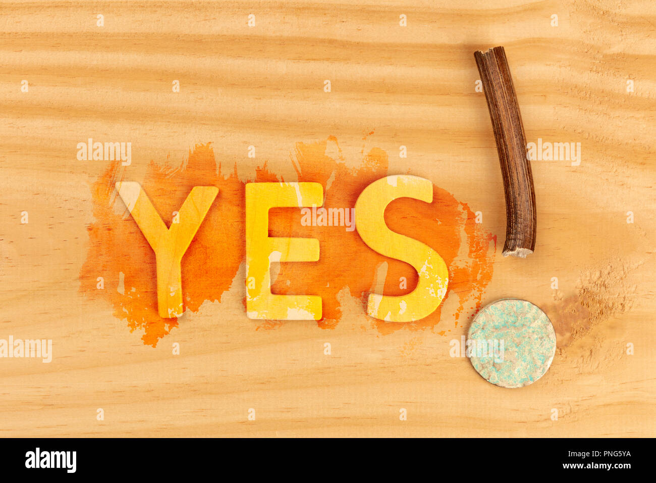 Yes, painted letters forming the word on a wooden background with ...