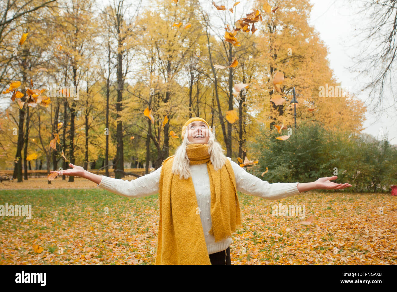 Autumn woman outdoor. Girl having fun in fall park Stock Photo - Alamy