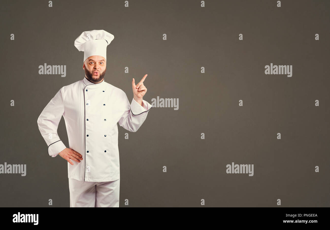 Funny cheerful chef in white uniform on background for text Stock Photo ...