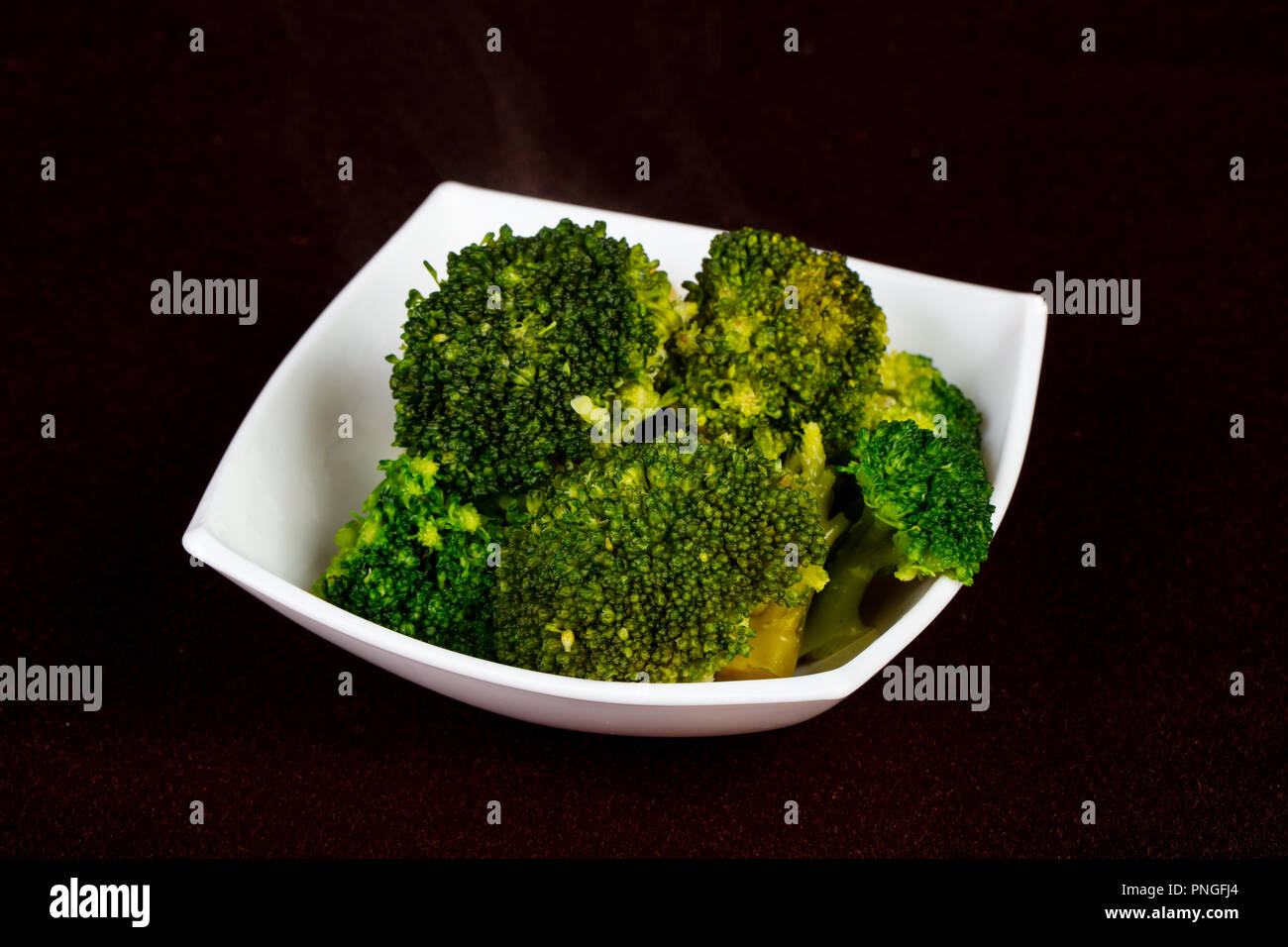 Steamed broccoli in the plate - vegan cuisine Stock Photo - Alamy