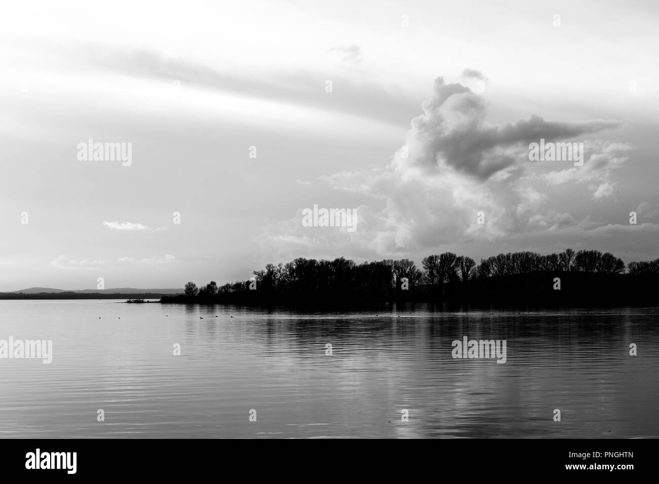 A shoot of a sunset over a lake, with beautiful warm colors and clouds ...