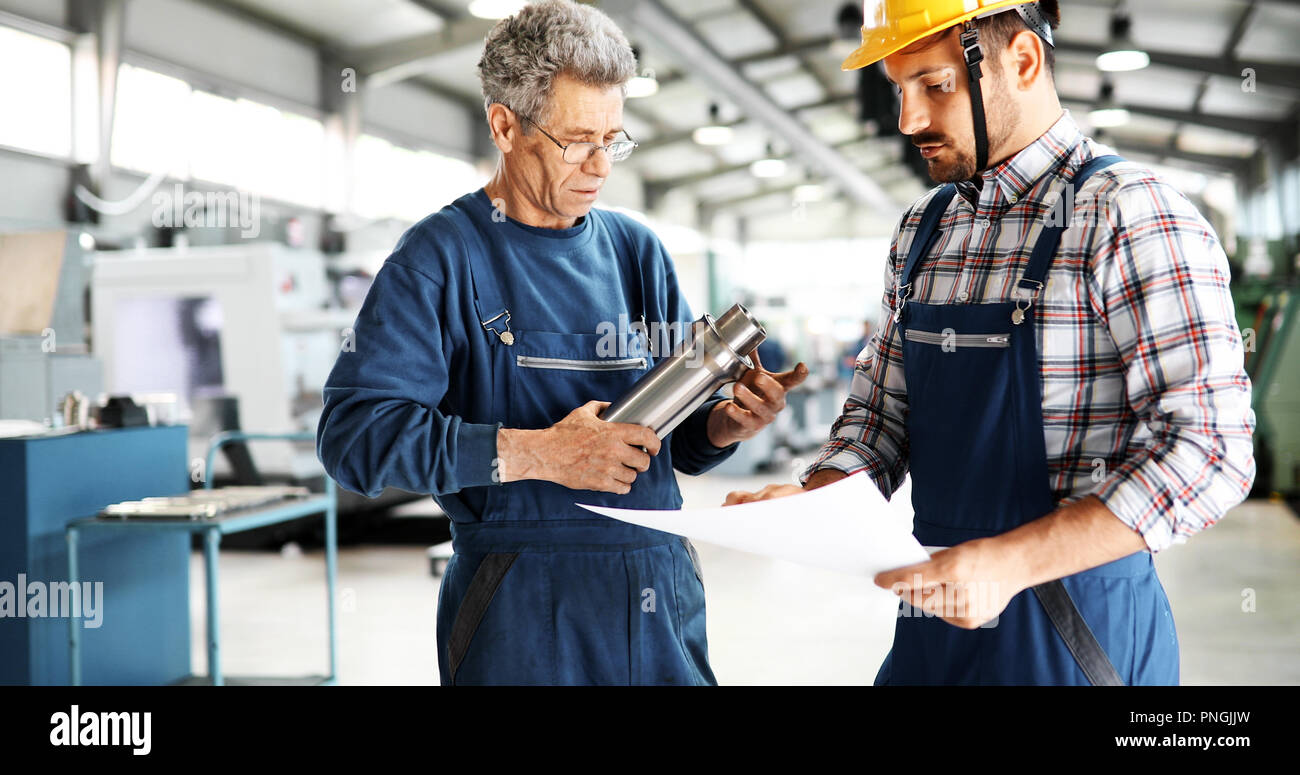 Team Of Engineers Having Discussion In Factory Stock Photo - Alamy