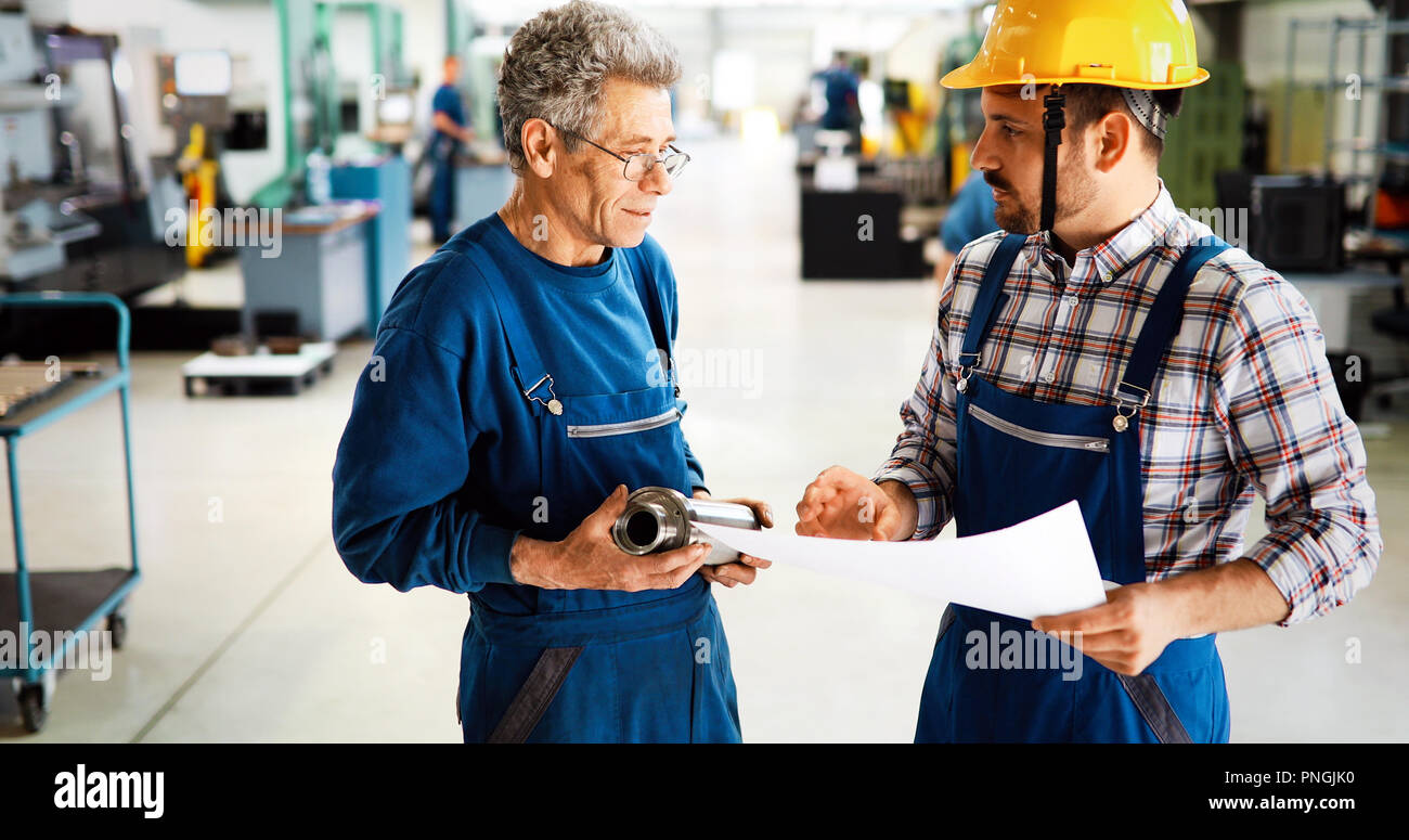 Team Of Engineers Having Discussion In Factory Stock Photo - Alamy