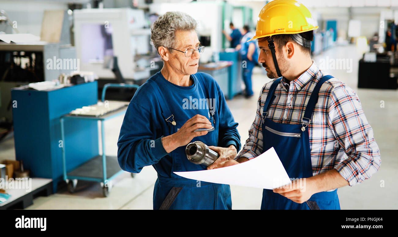 Supplier with engineer checking on production in factory Stock Photo ...