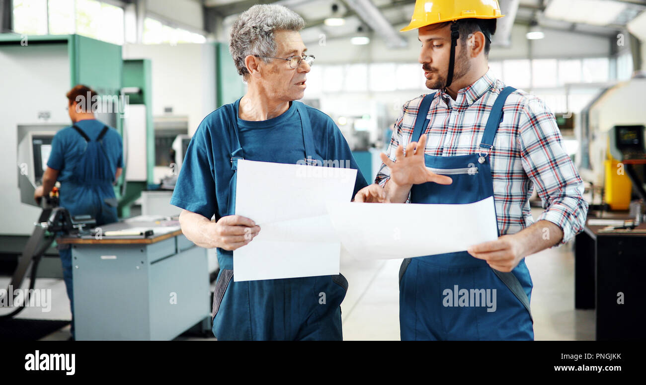Team Of Engineers Having Discussion In Factory Stock Photo - Alamy