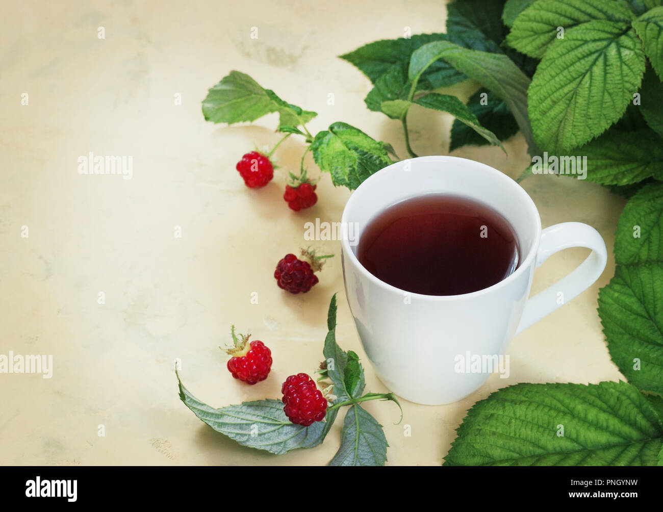Raspberry tea with leaves and raspberries on a light background Stock ...