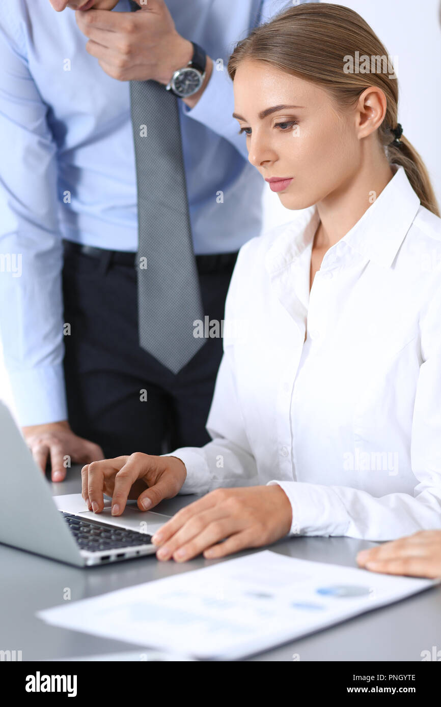 Group of business people using laptop computer in office. Meeting and ...