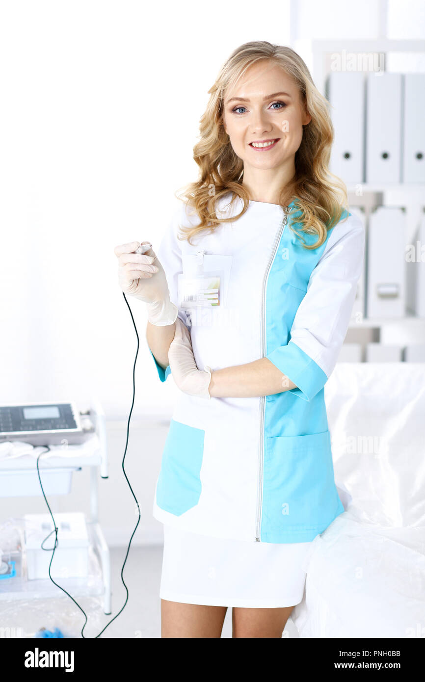 Portrait of professional female beautician standing straight in beauty ...