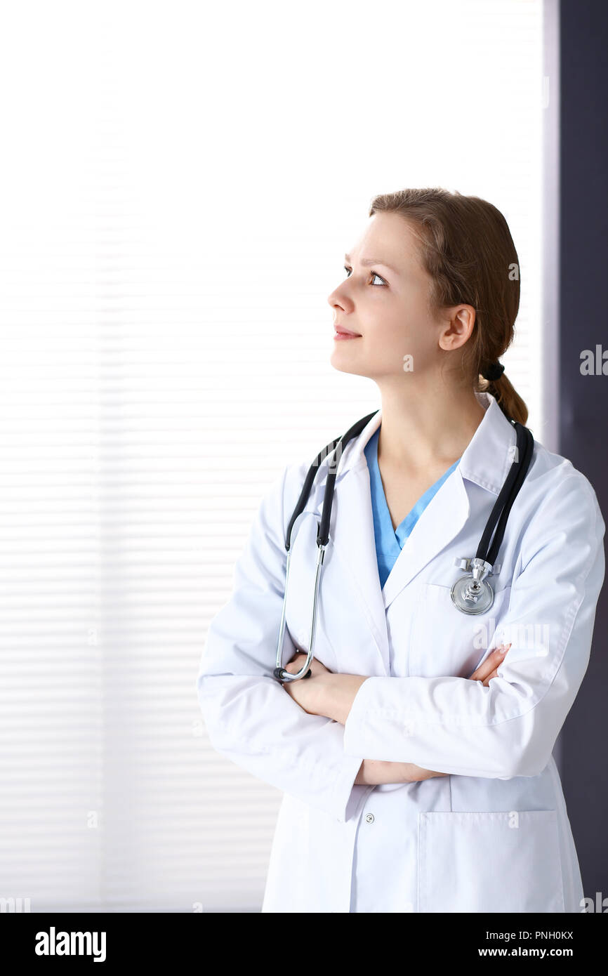 Female doctor looking up information hi-res stock photography and ...
