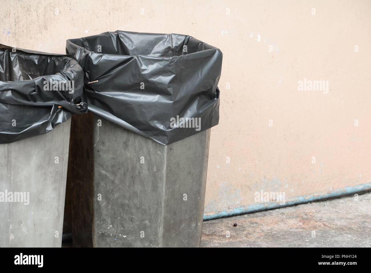 black garbage bag plastic wear in trashcan Stock Photo - Alamy