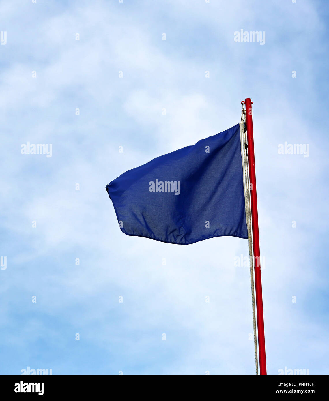 blue flag waves on the blue sky. This is the symbol of not pollution in ...
