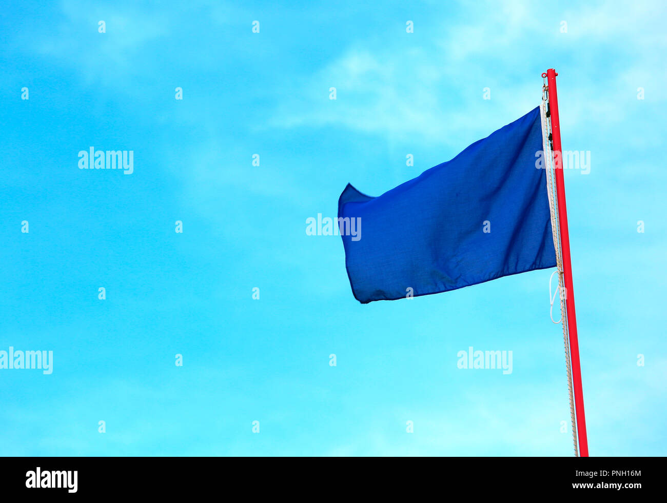 blue flag waves on the blue sky. this is a symbol indicates an area ...