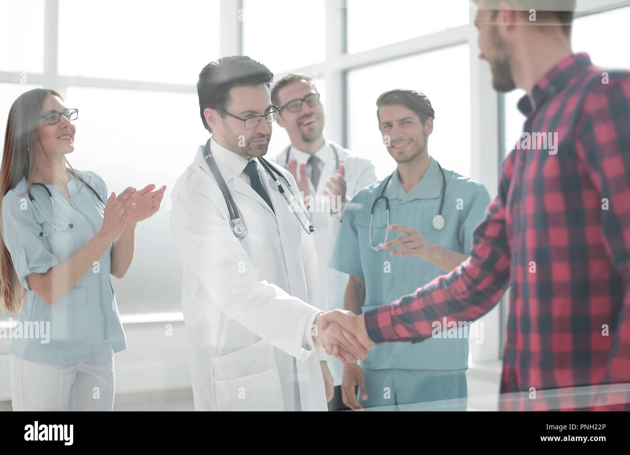 Thankful patient shaking doctors hand Stock Photo - Alamy