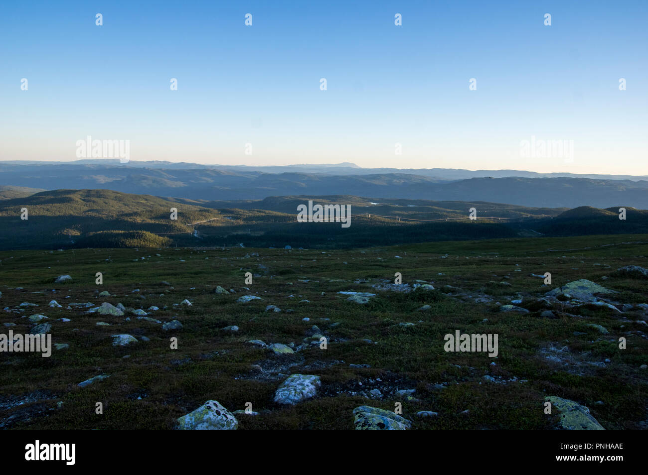 Top hill view over the landscape and mountains Stock Photo - Alamy