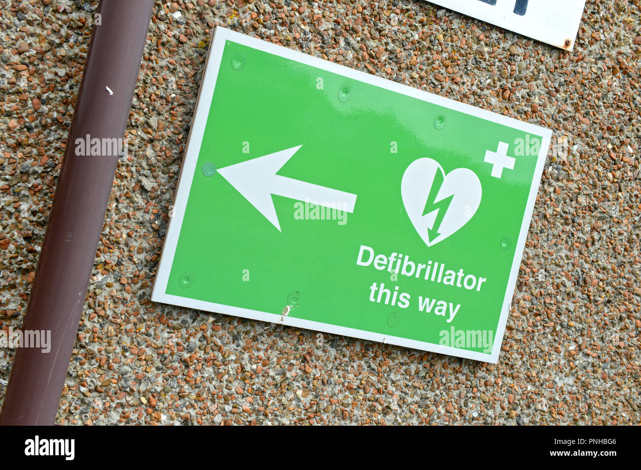 Defibrillator signage on wall outside of public toilets in Skeld ...