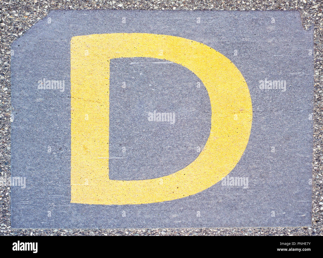Letter D painted on the concrete pavement at the train station Stock ...