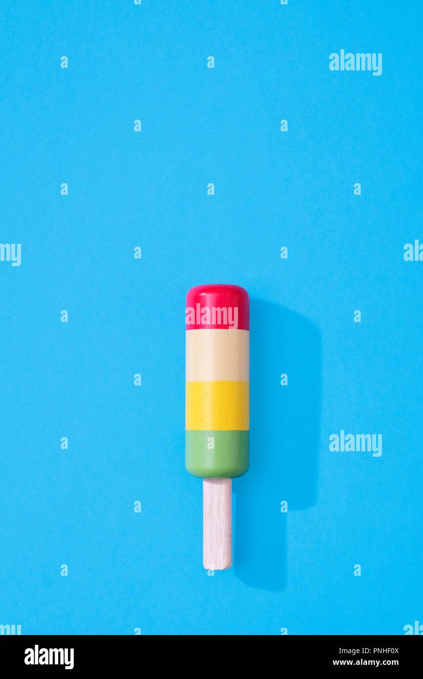 Classic round wooden toy ice lollipop popsicle on a pastel blue ...