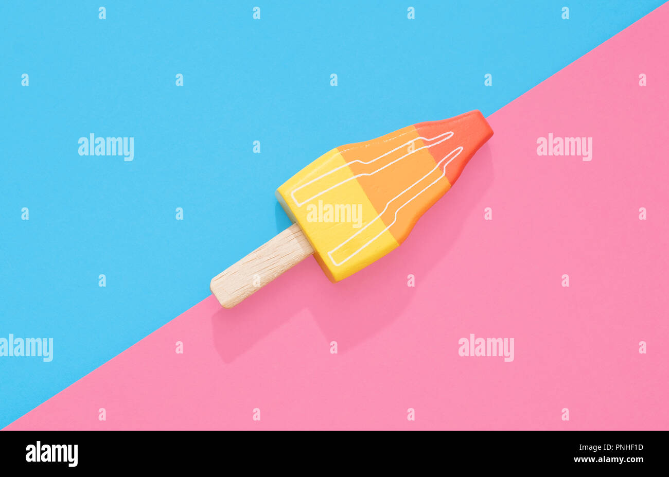 Wooden toy classic rocket ice lollipop popsicles on a split pink and ...