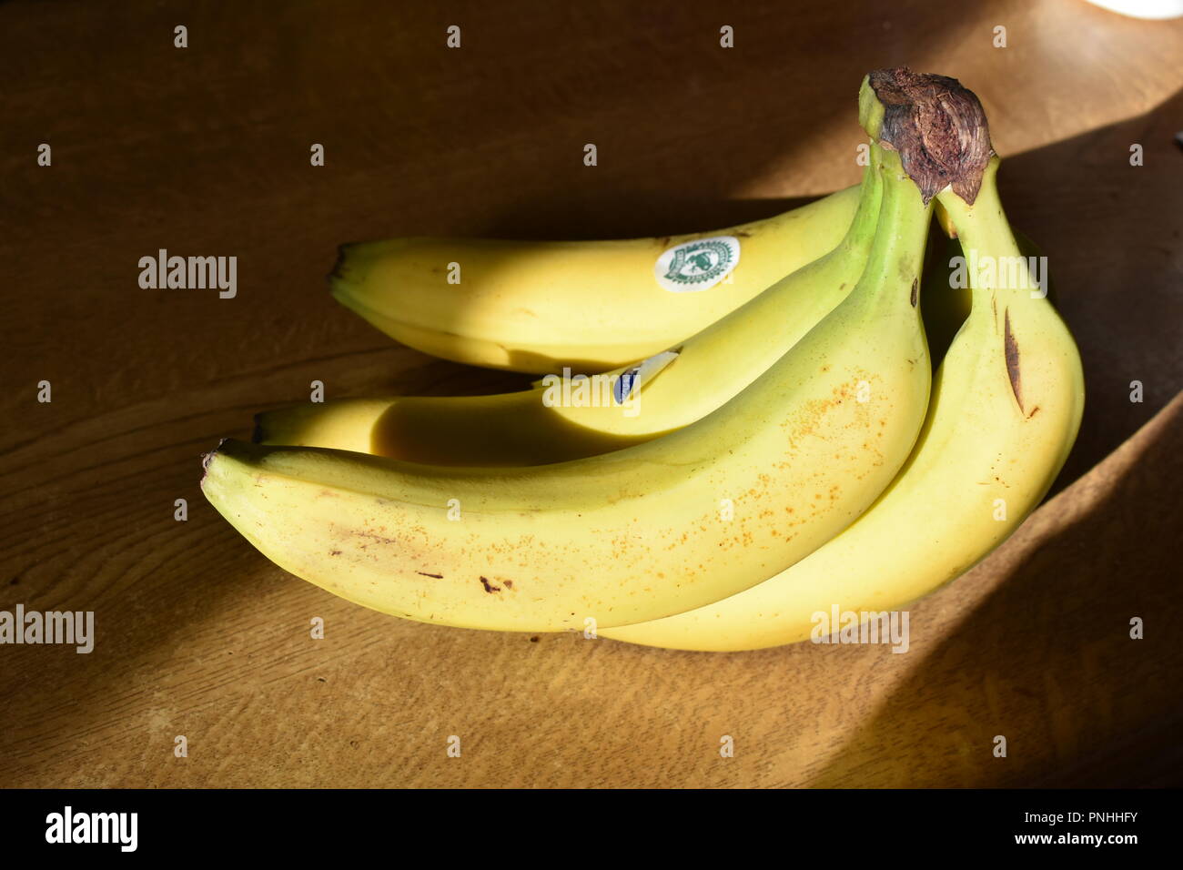 Bananas in sunlight Stock Photo - Alamy