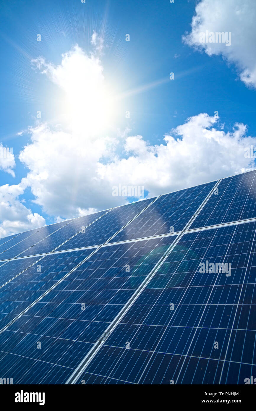 Blue solar panels over blue sky. Renewable energy Stock Photo - Alamy