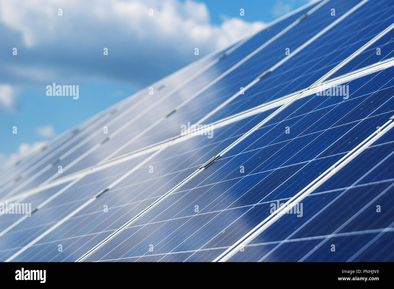 Blue solar panels over blue sky. Renewable energy Stock Photo - Alamy