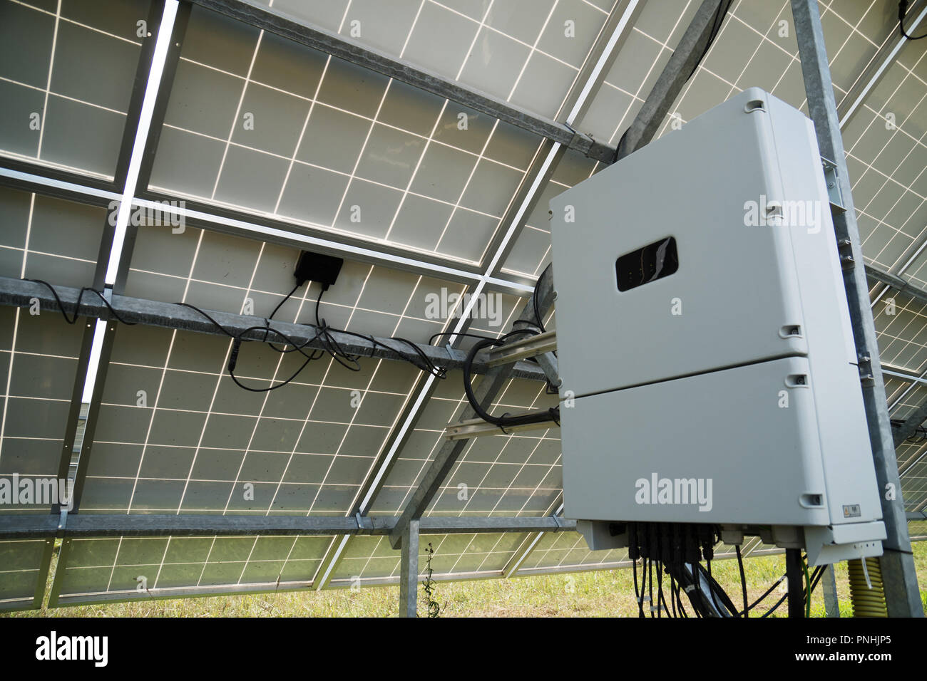 Inverter behind the solar panels. Renewable energy Stock Photo - Alamy