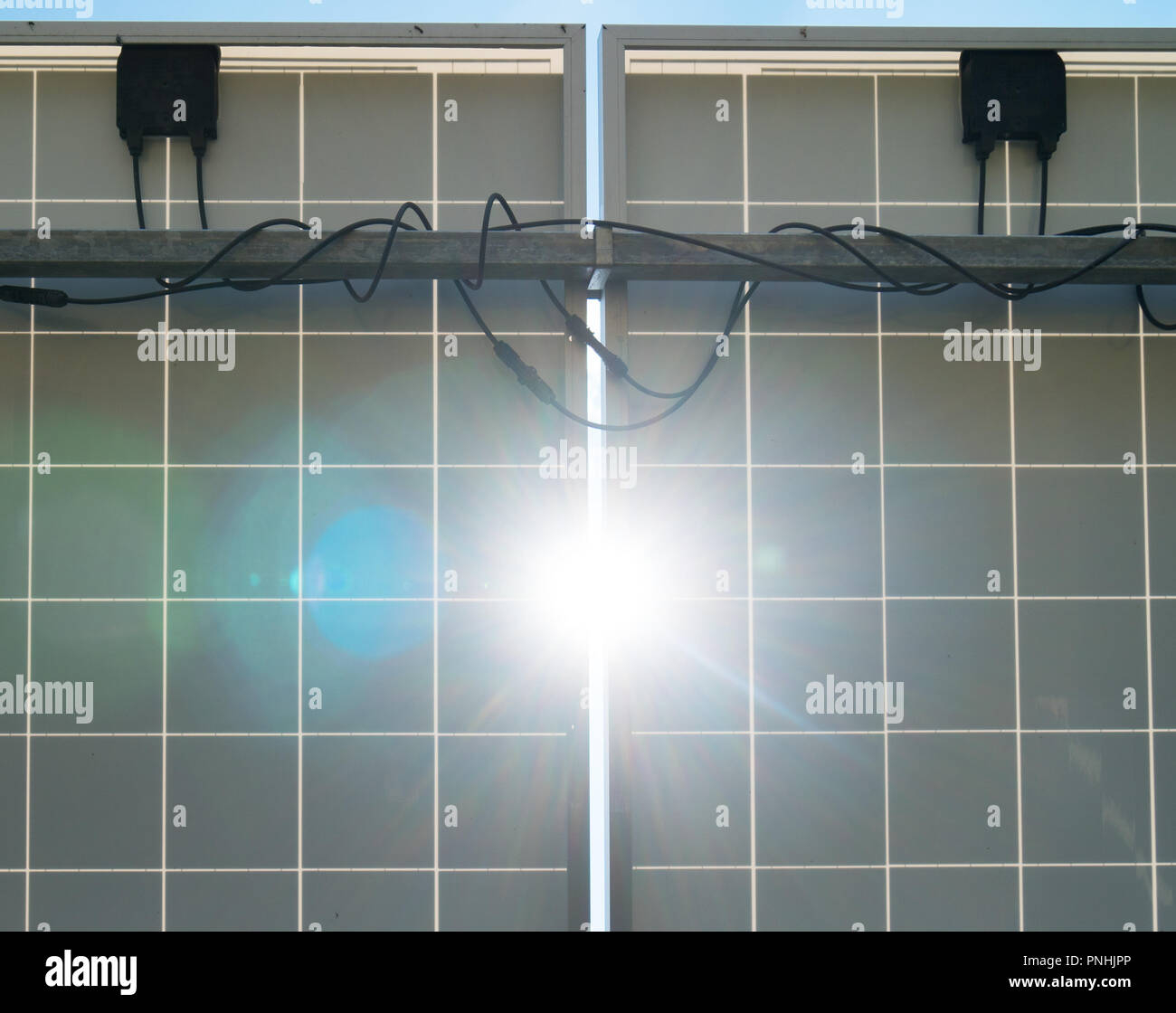 Behind the solar panels. Renewable energy Stock Photo - Alamy