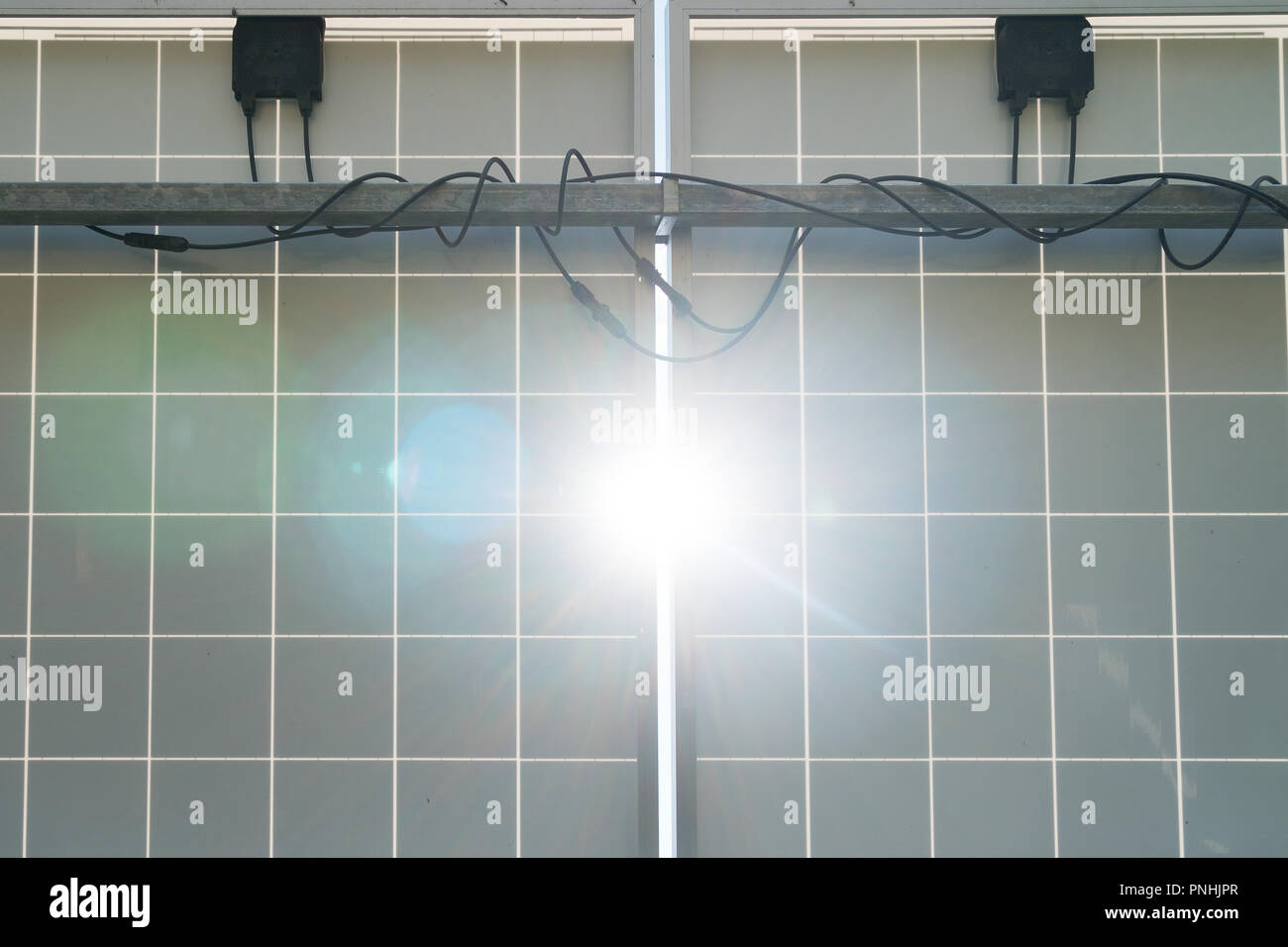 Behind the solar panels. Renewable energy Stock Photo - Alamy