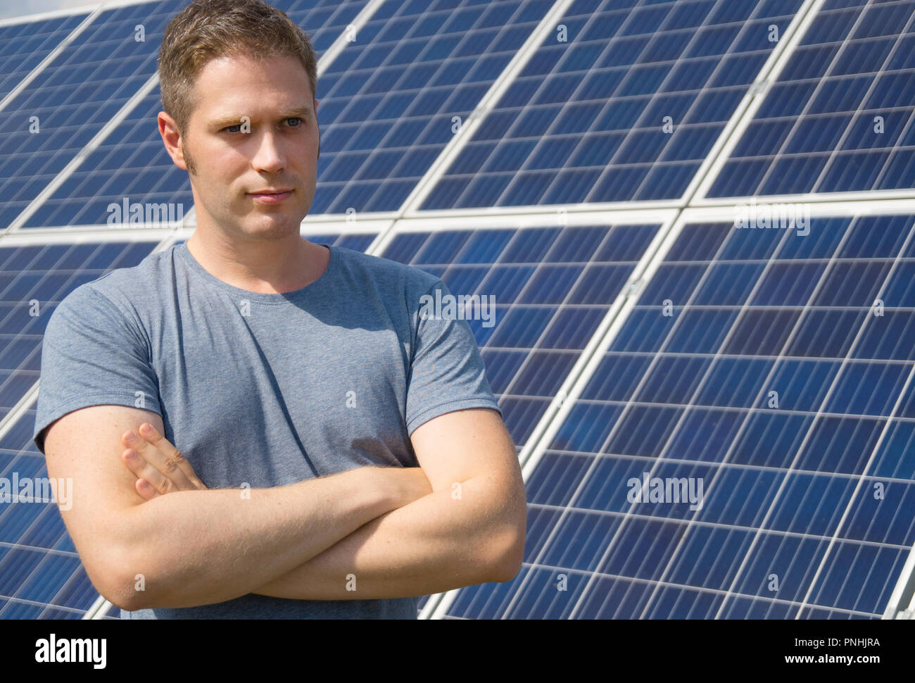 Man standing in front of solar panels. Renewable energy Stock Photo - Alamy