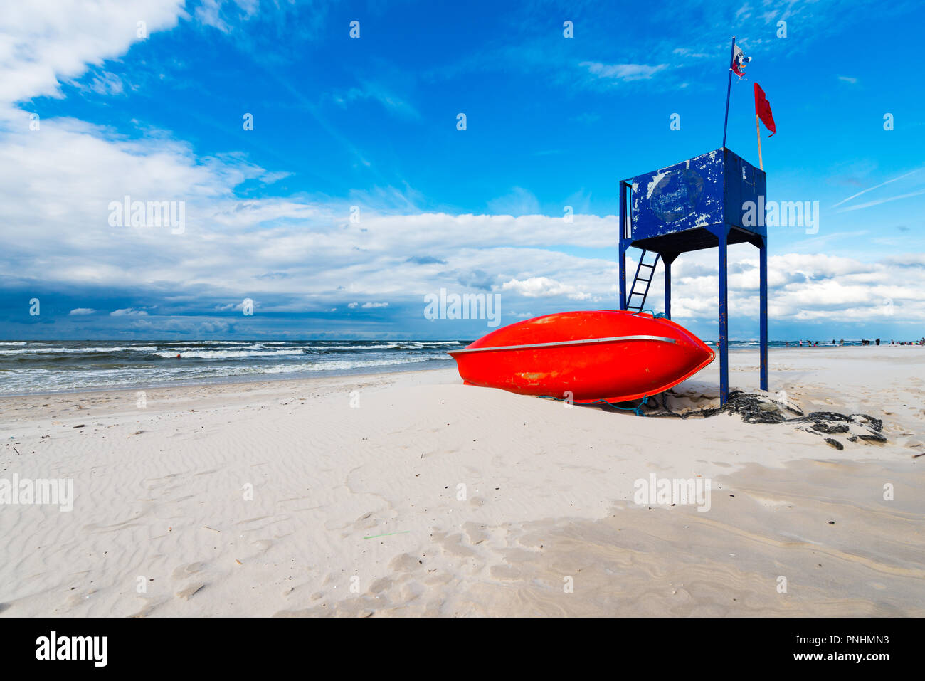 lifeguard tower and lifeboat on the beach - with blue cloudy sky in ...